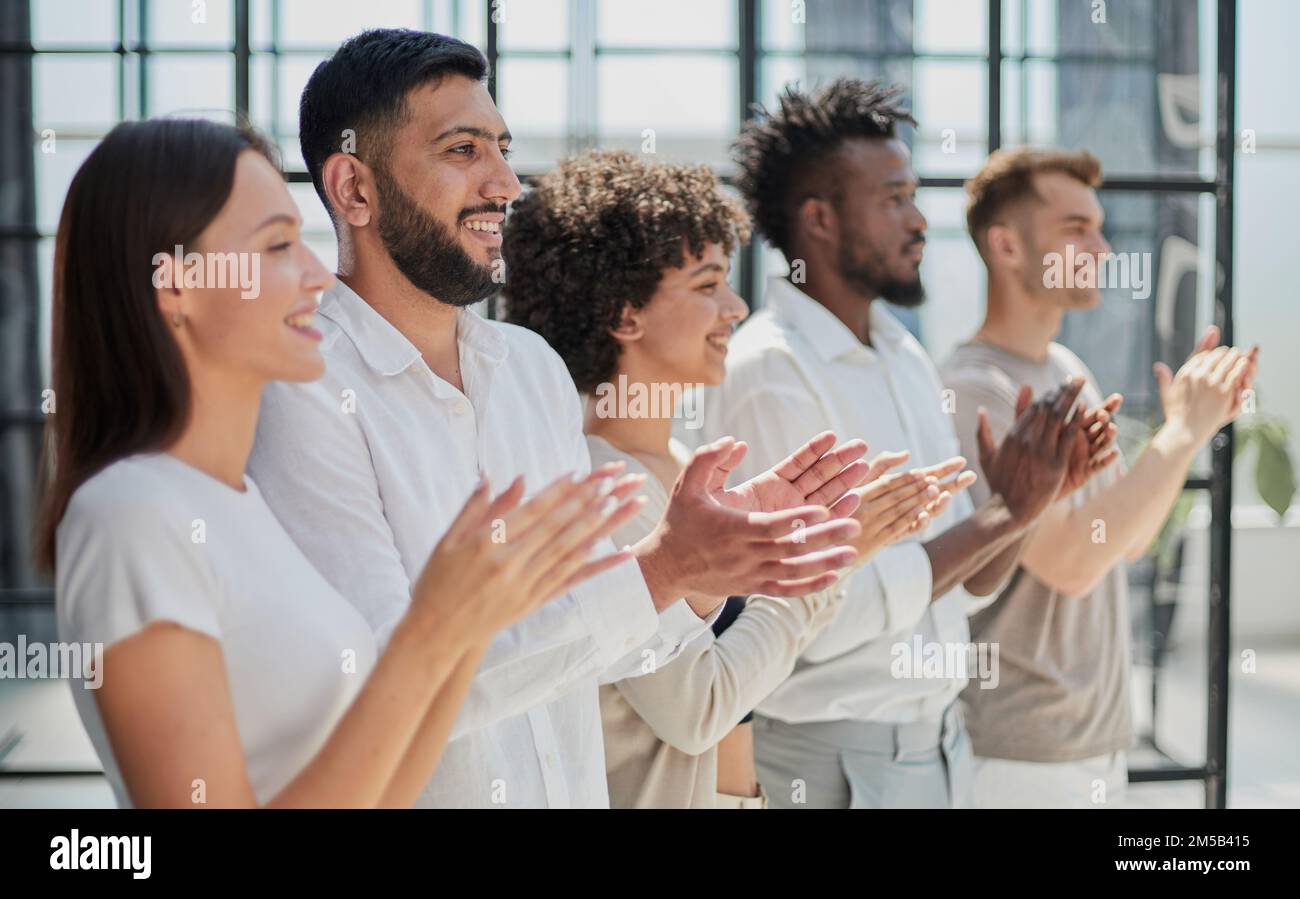 Group of businesspeople sitting in a line and applauding Stock Photo ...