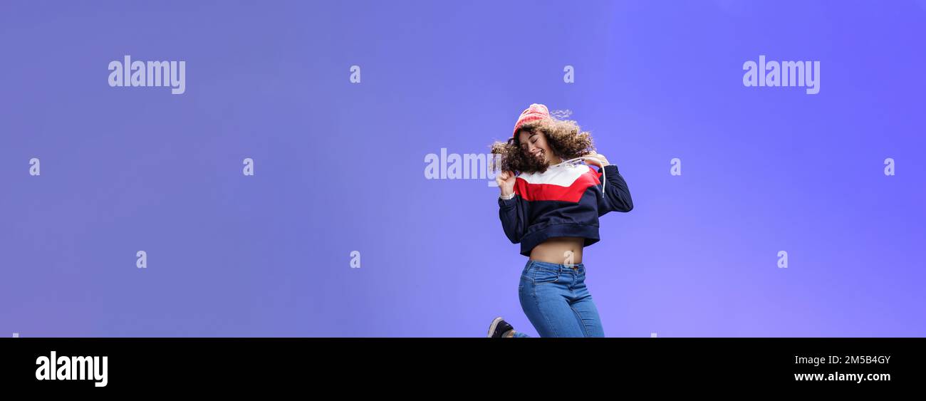 Girl jumping from happiness and delight feeling carefree close eyes and ...