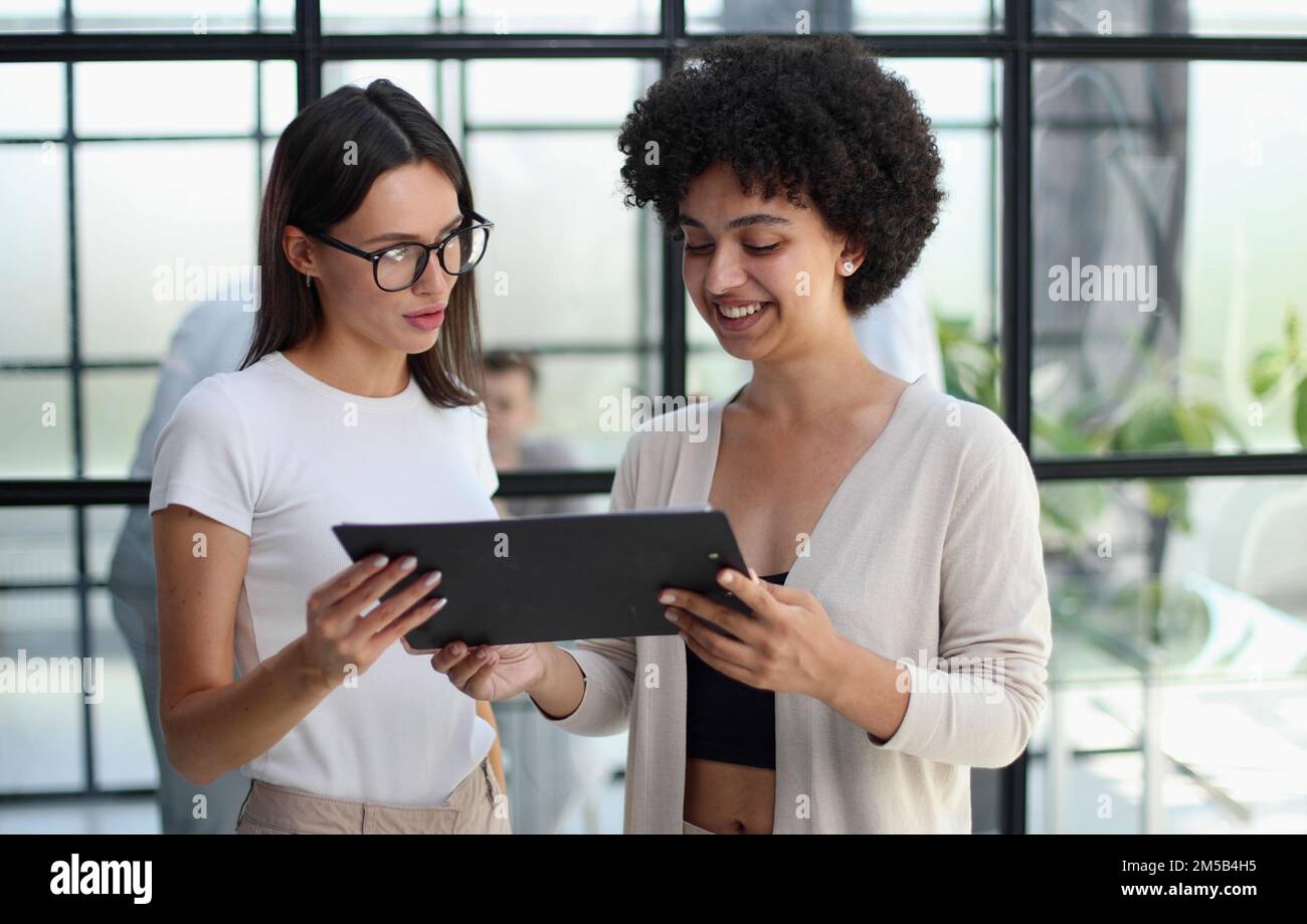 Two women analyzing documents office. Woman executives at work in ...