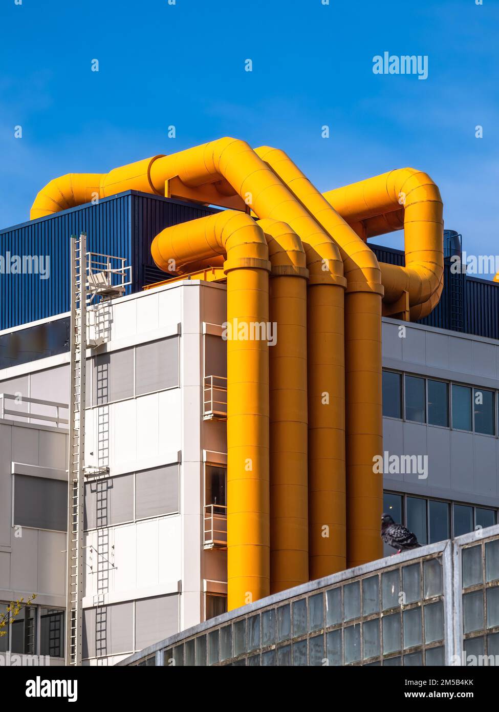 Yellow pipes on the exterior facade of a building in Rotterdam Stock ...