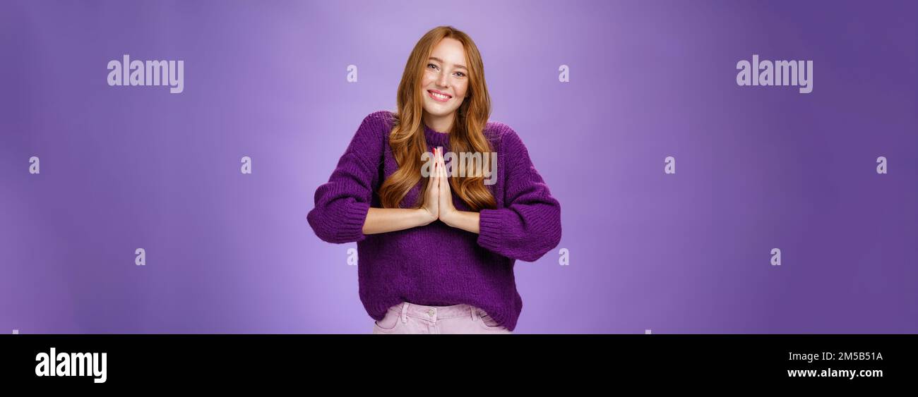 Cute redhead girl with angel look supplicating asking for help or ...
