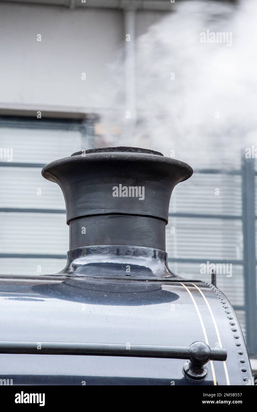 A black steam train funnel with steam Stock Photo - Alamy