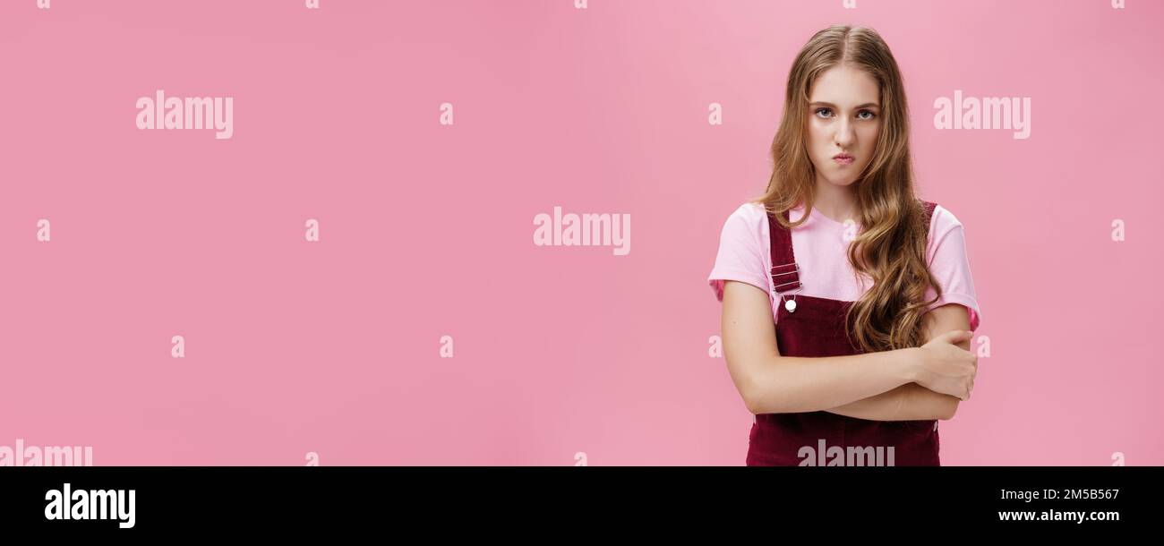 I mad on world. Unhappy hateful young arrogant girl in overalls with ...