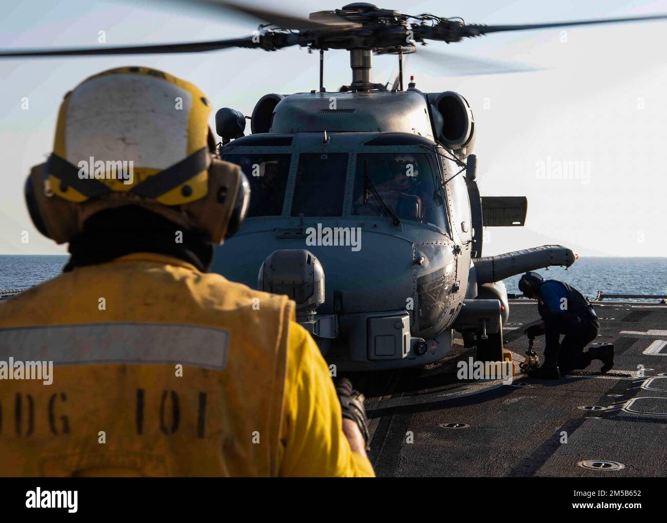 GULF OF OMAN (Feb. 18, 2022) Seaman Nicholas Steinhaus, left, directs ...