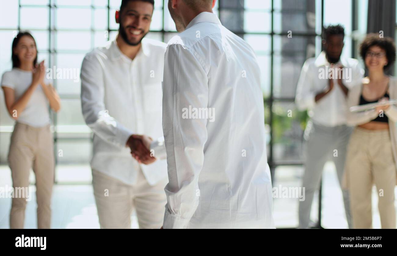 Congratulating the new partners in modern office Stock Photo - Alamy