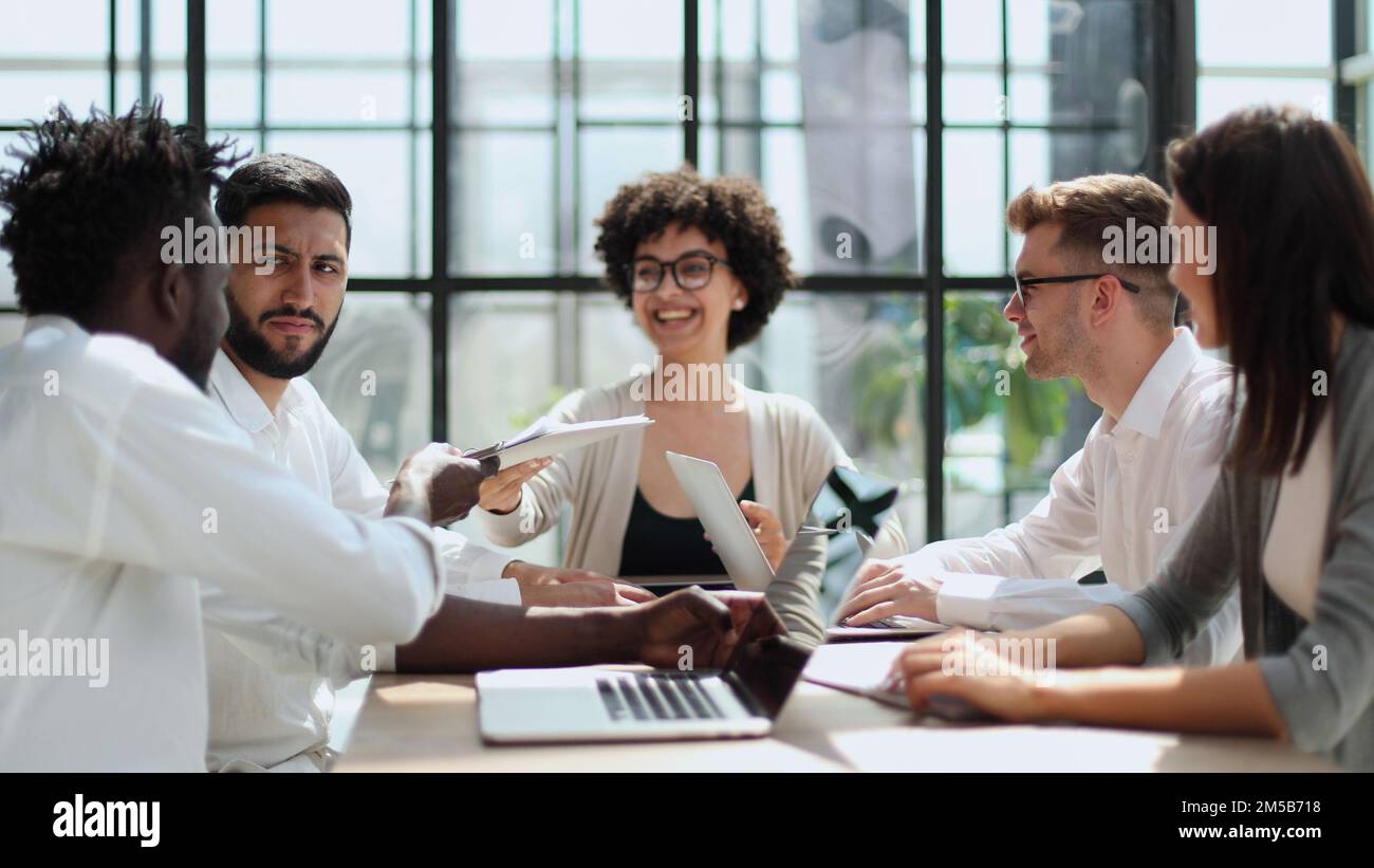Employees working at computer together, discussing content Stock Photo ...