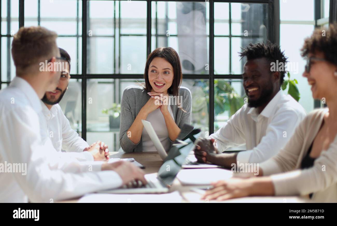Employees working at computer together, discussing content Stock Photo ...