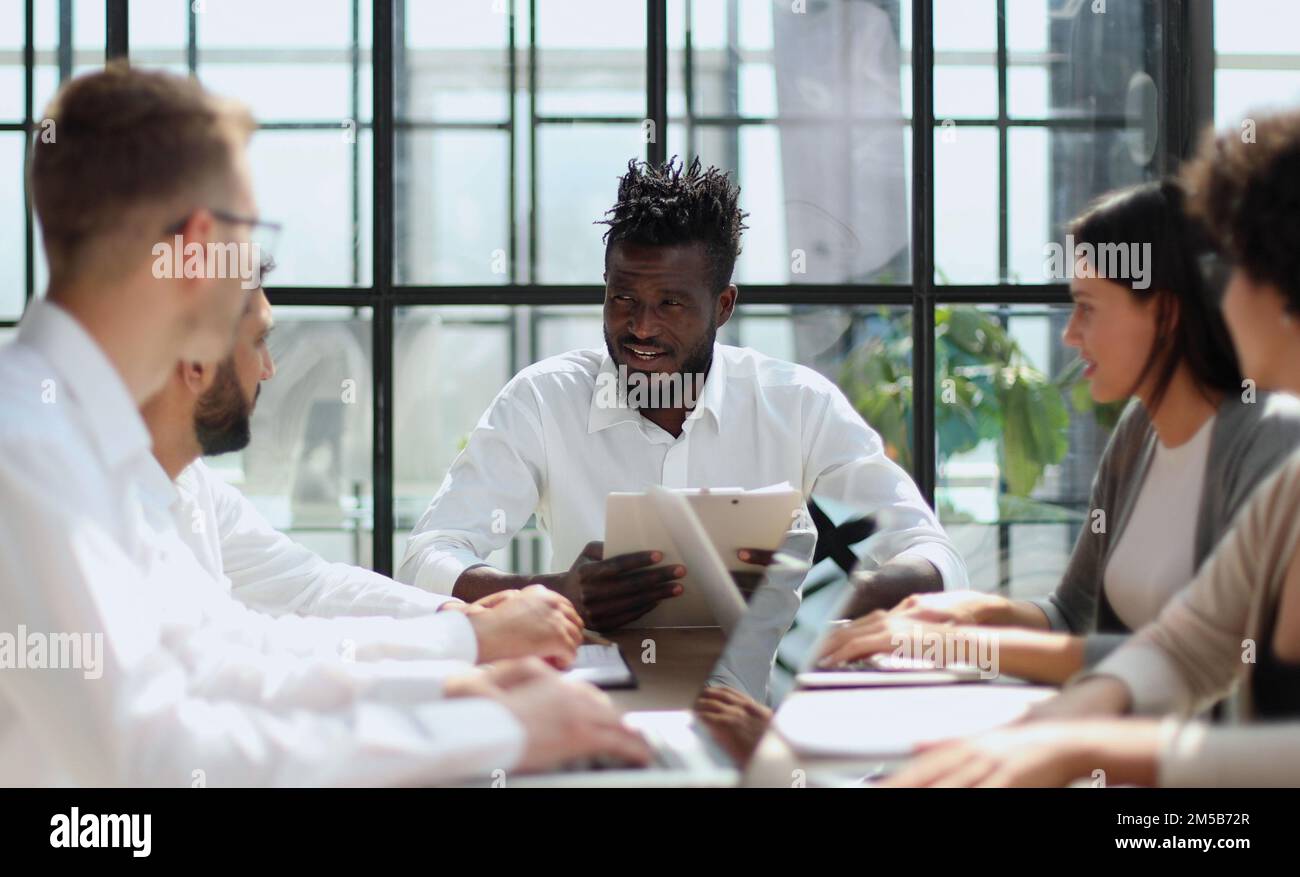 Employees working at computer together, discussing content Stock Photo ...