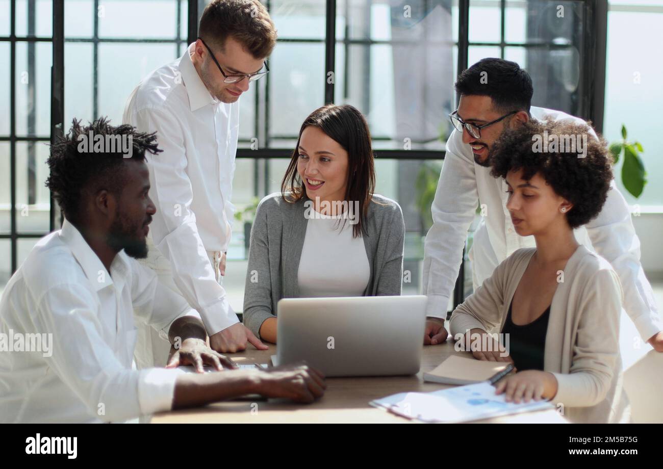 Employees working at computer together, discussing content Stock Photo ...