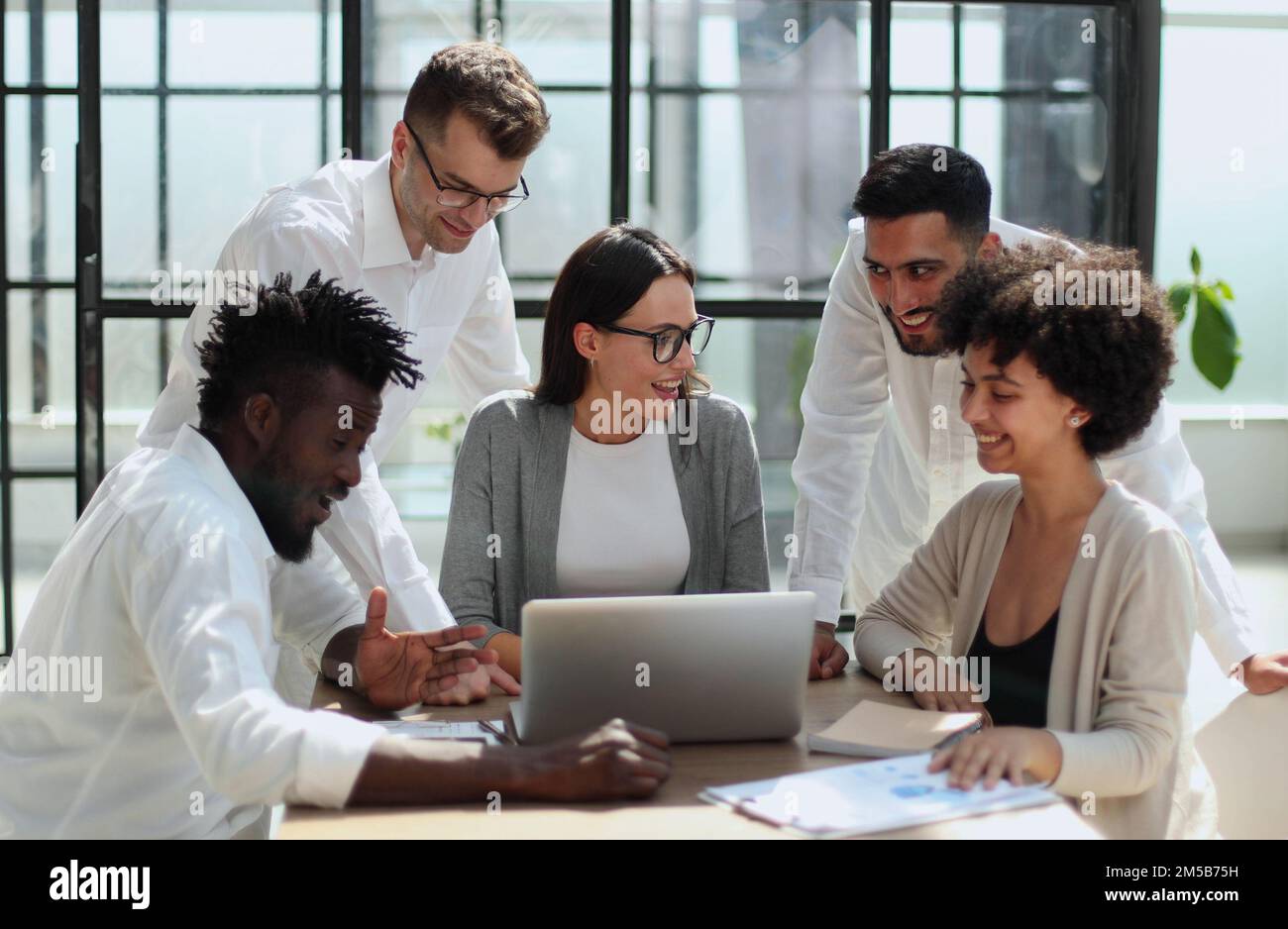 Employees working at computer together, discussing content Stock Photo ...