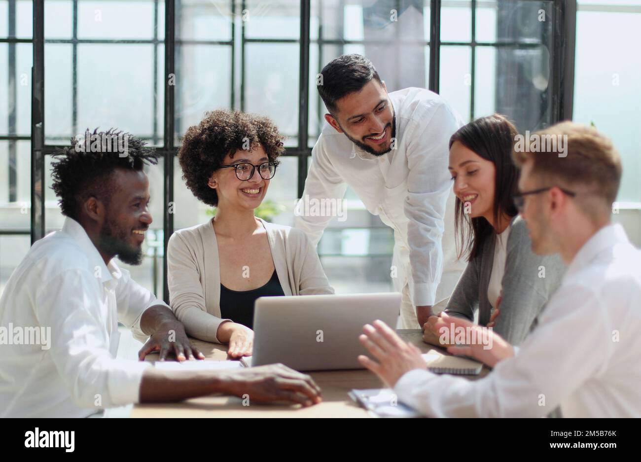 Employees working at computer together, discussing content Stock Photo ...