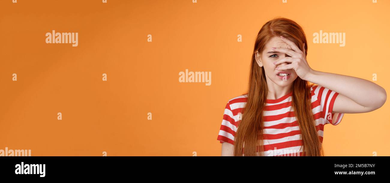 Uneasy redhead girl pity for bad situation, trying not look awful ...