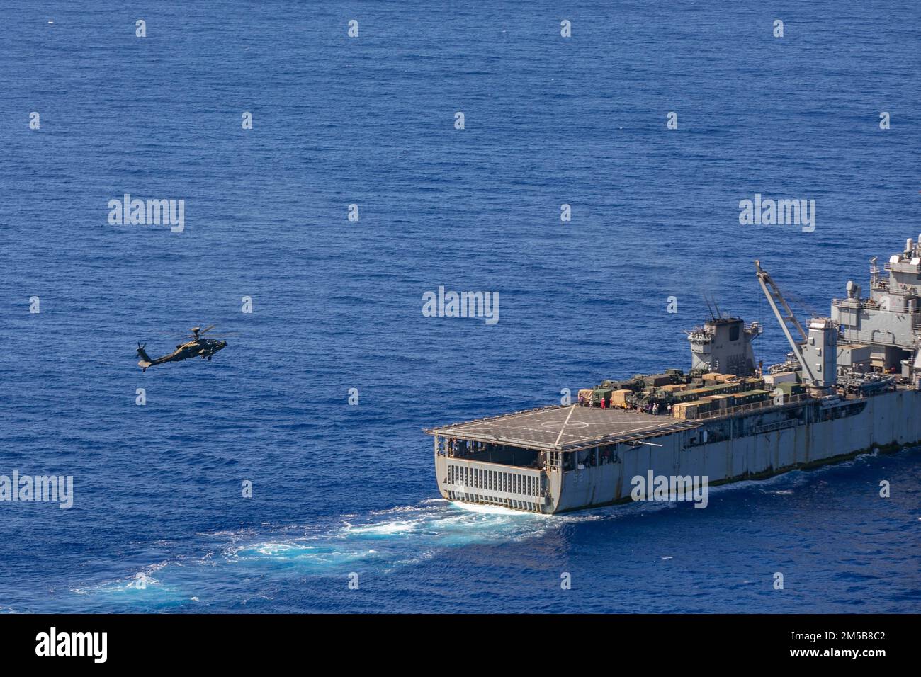 U.S. Army Boeing AH-64 Apache helicopter prepares to land aboard the ...