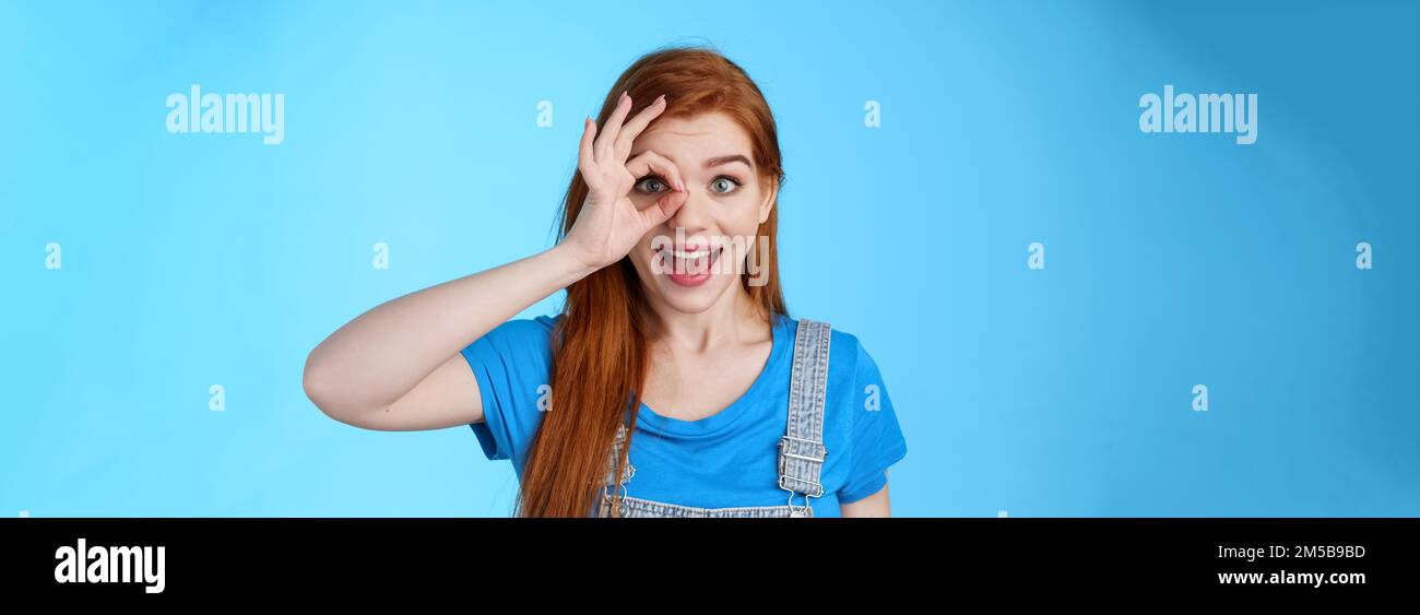 Dreamy curious attractive cheerful redhead woman surprised, look ...