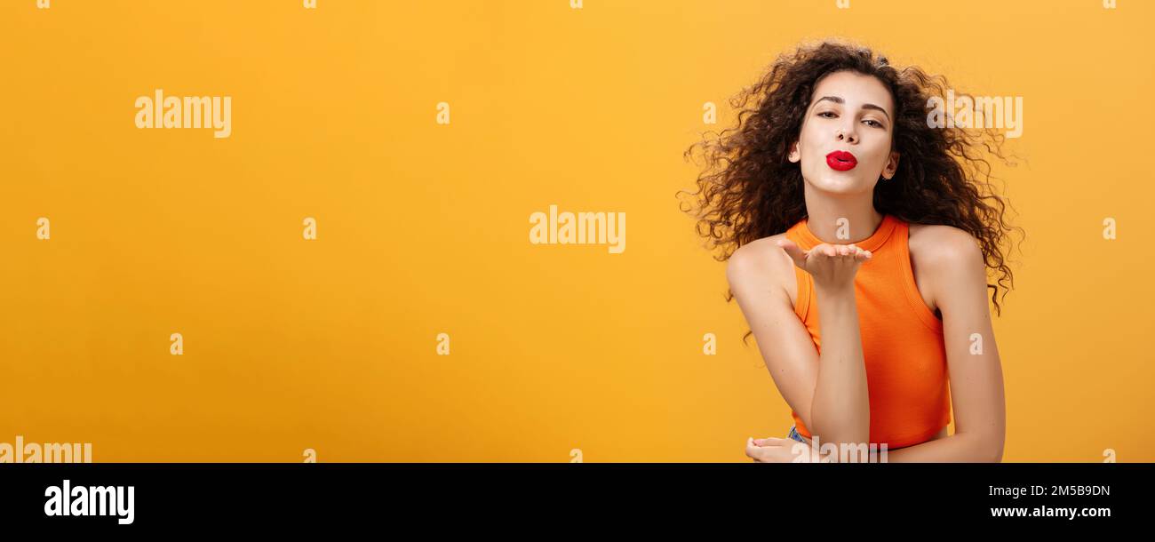 Flirty confident and sensual stylish woman with curly hairstyle and red ...