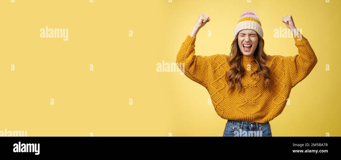 Relieved attractive fashionable university female student yelling ...