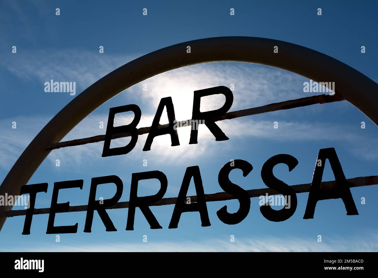 Metal sign indicating the entrance to a terrace and bar Stock Photo - Alamy
