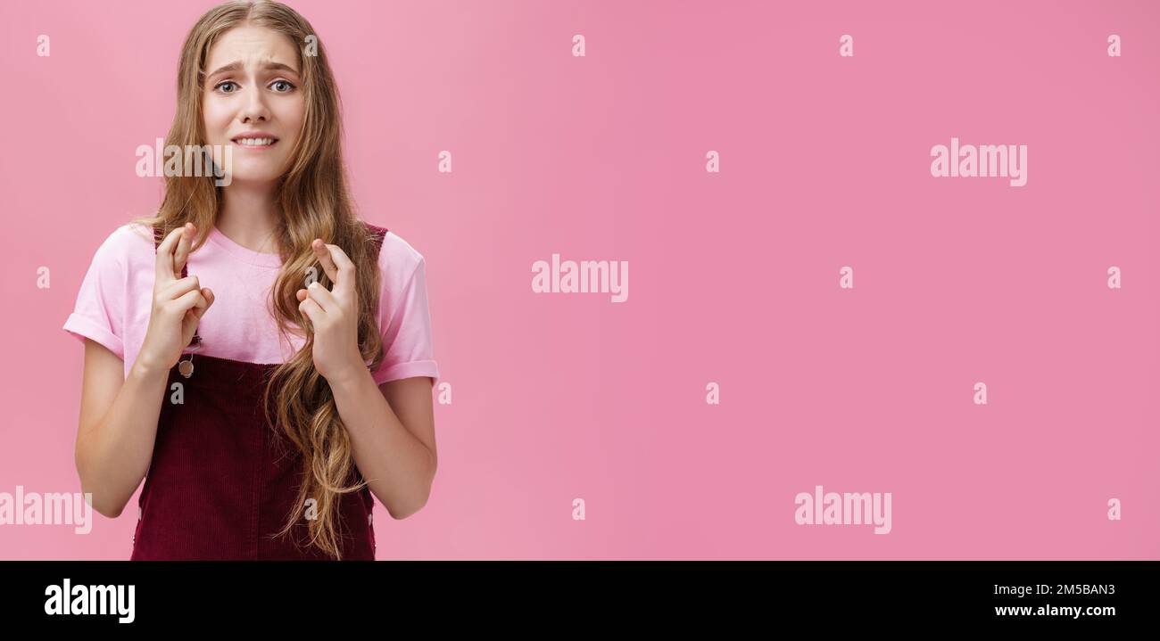 Intense worried cute messy woman with long fair wavy hair and makeup ...