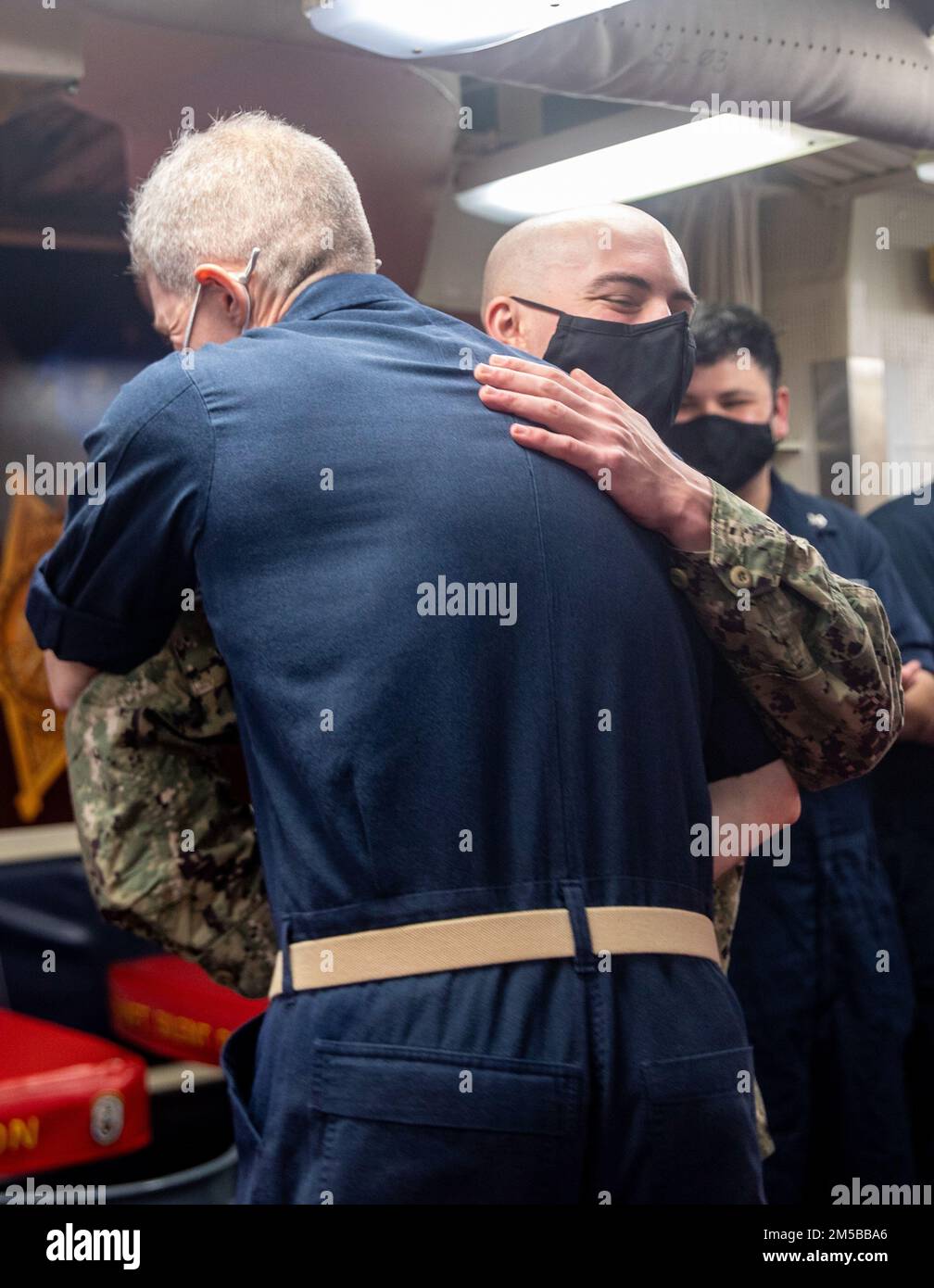 SOUTH CHINA SEA (Feb. 18, 2022) Cmdr. Colin Roberts (left), from Lake ...