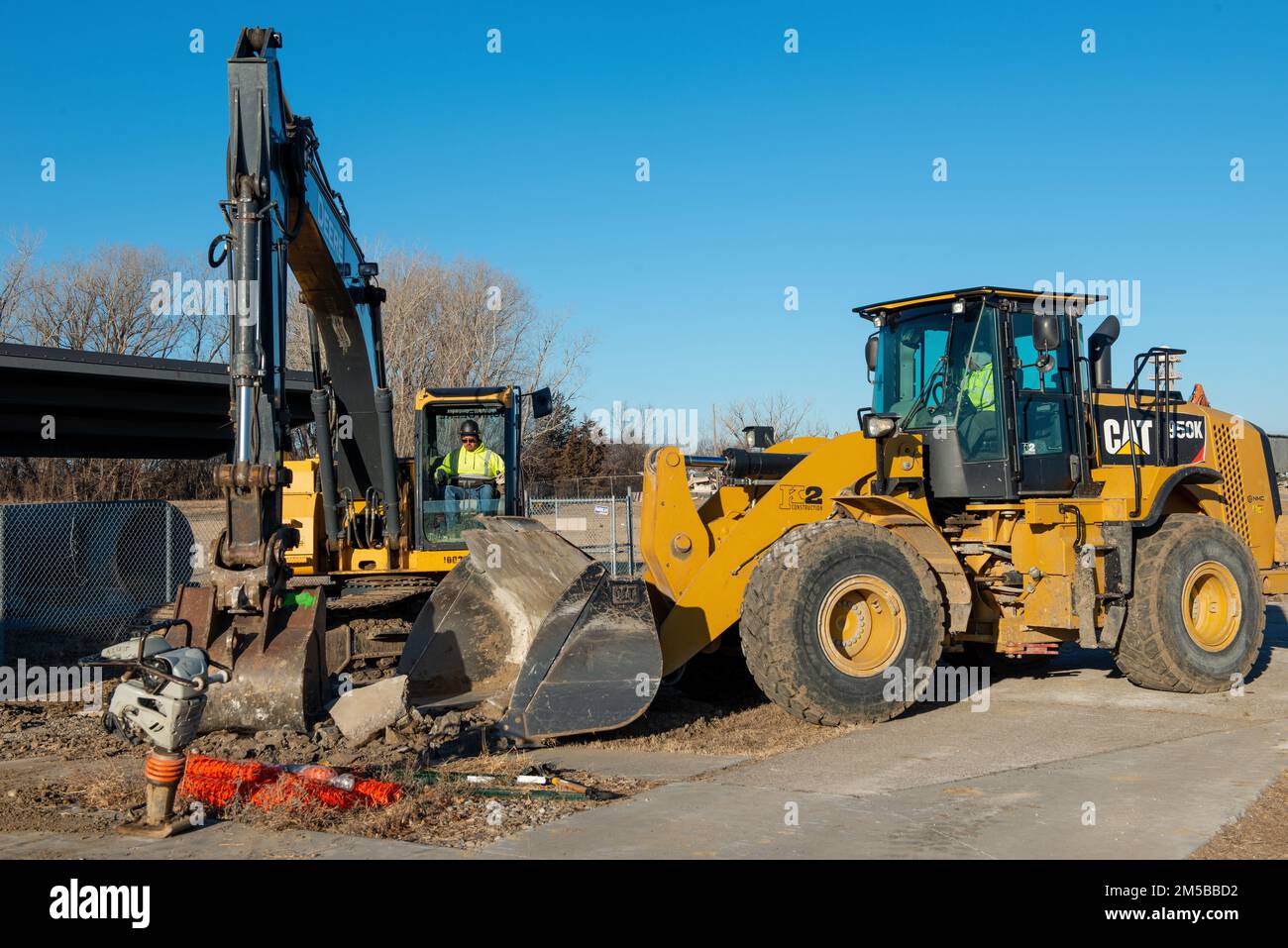 Heavy machinery removes rubble after a building is demolished on Offutt ...