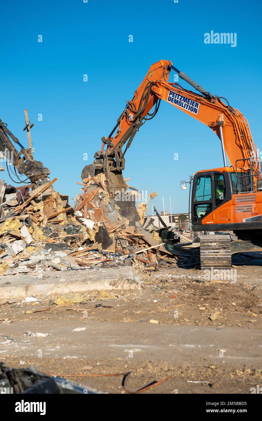 Heavy machinery removes rubble after a building is demolished on Offutt ...