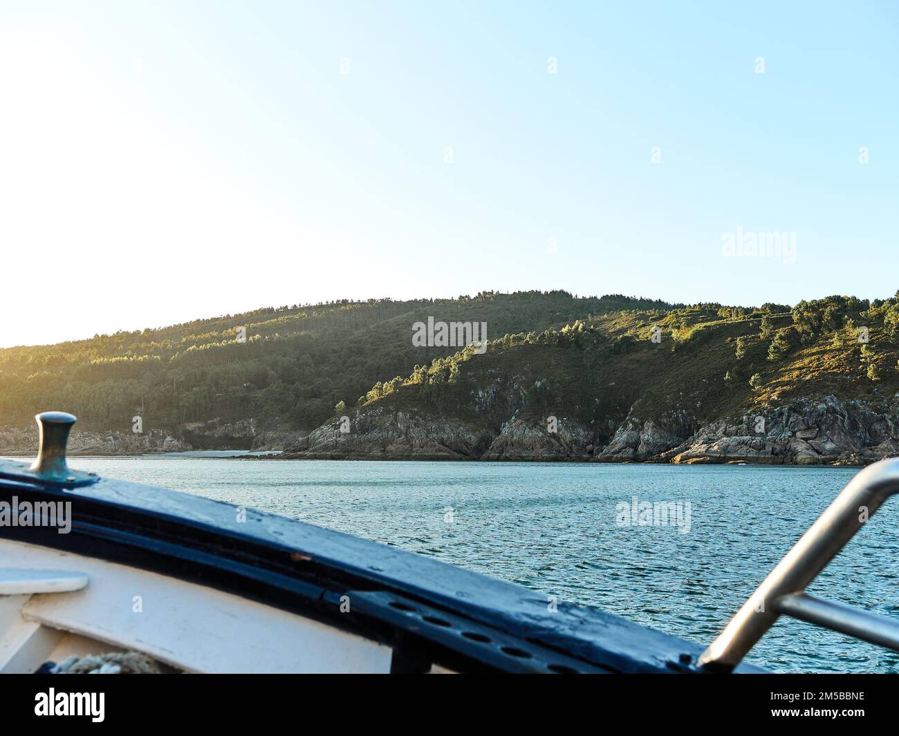 A View to land from a ship at sea during sunset Stock Photo - Alamy