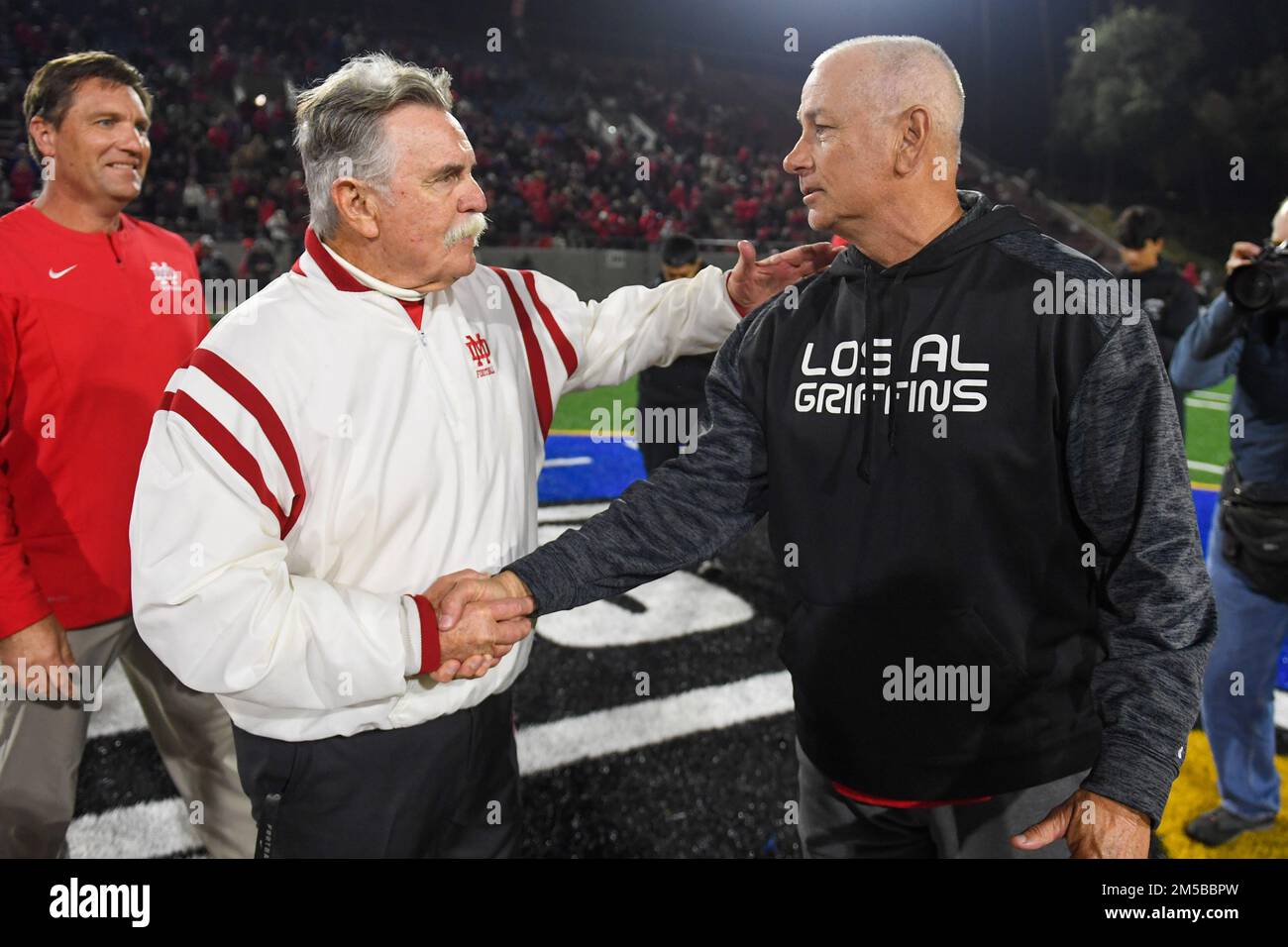 Mater Dei Monarchs head coach Bruce Rollinson (left) shakes hands with ...