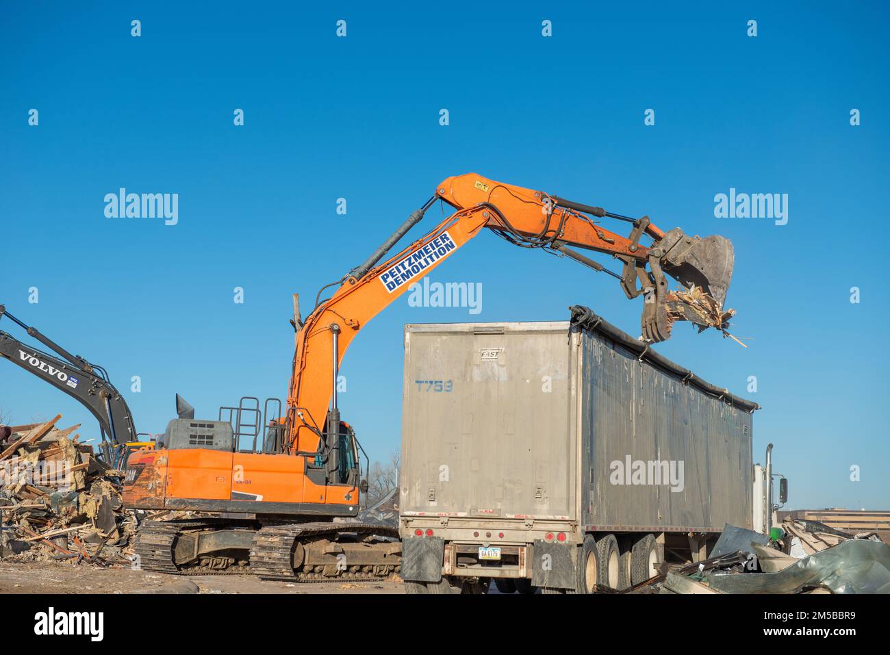 Heavy machinery removes rubble after a building is demolished on Offutt ...