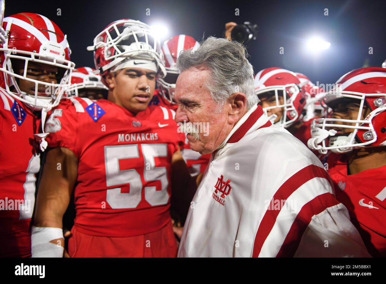 Mater Dei Monarchs head coach Bruce Rollinson is embraced by players ...