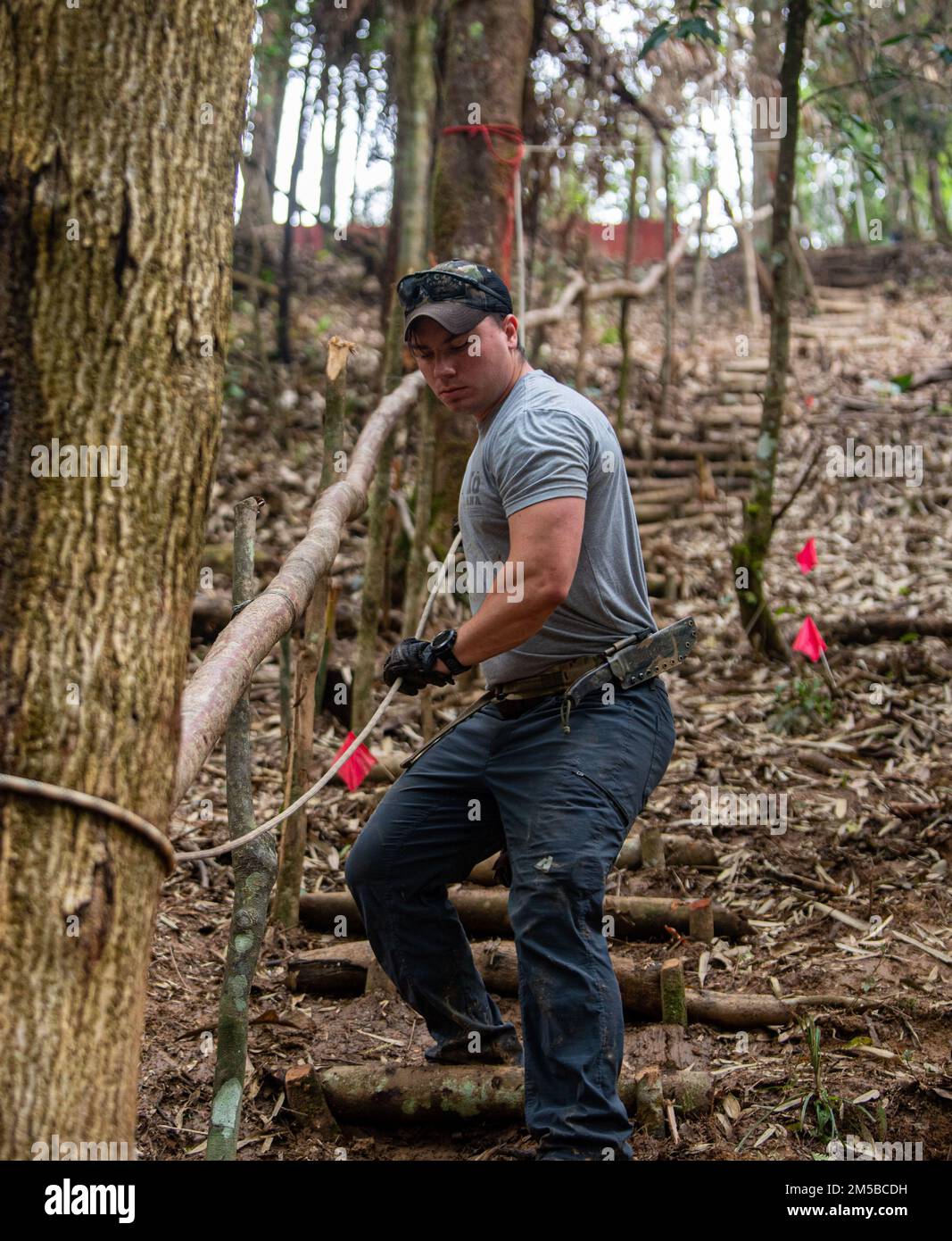 U.S. Army Staff Sgt. Ryan Philip travels down a set of stairs and ropes ...