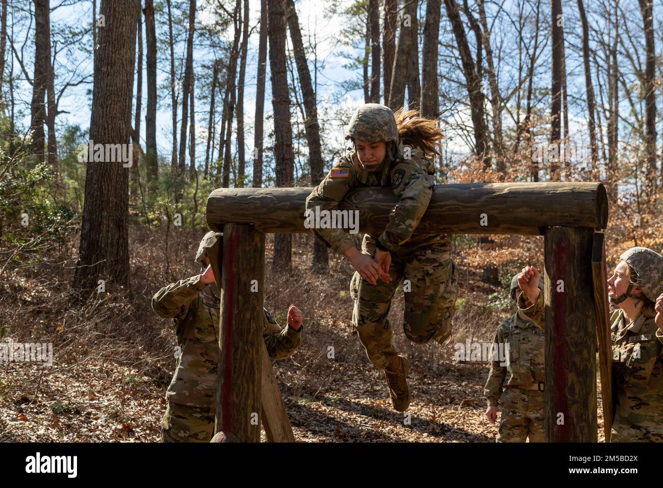 A Cadet from Christopher Newport University, leaps up to complete an ...