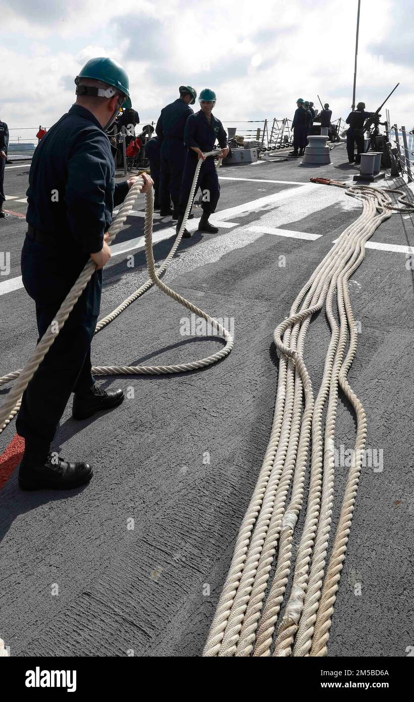 MALLACA STRAIT (Feb. 20, 2022) Sailors restow line below decks on the ...