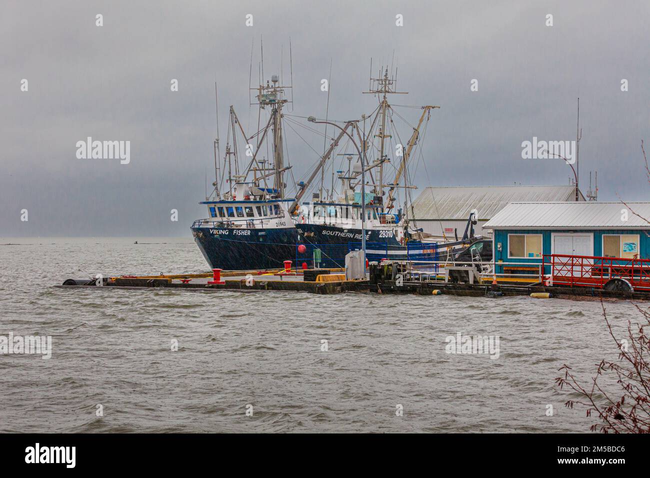 Partial submerged jetty during coastal flooding in Steveston British ...