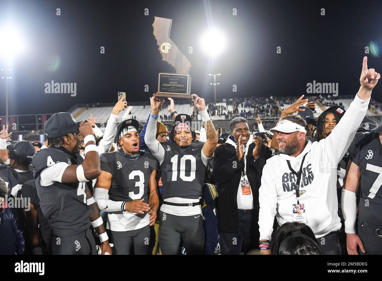 St. John Bosco Braves quarterback Pierce Clarkson (10) lifts the trophy after the 2022 CIF Open ...