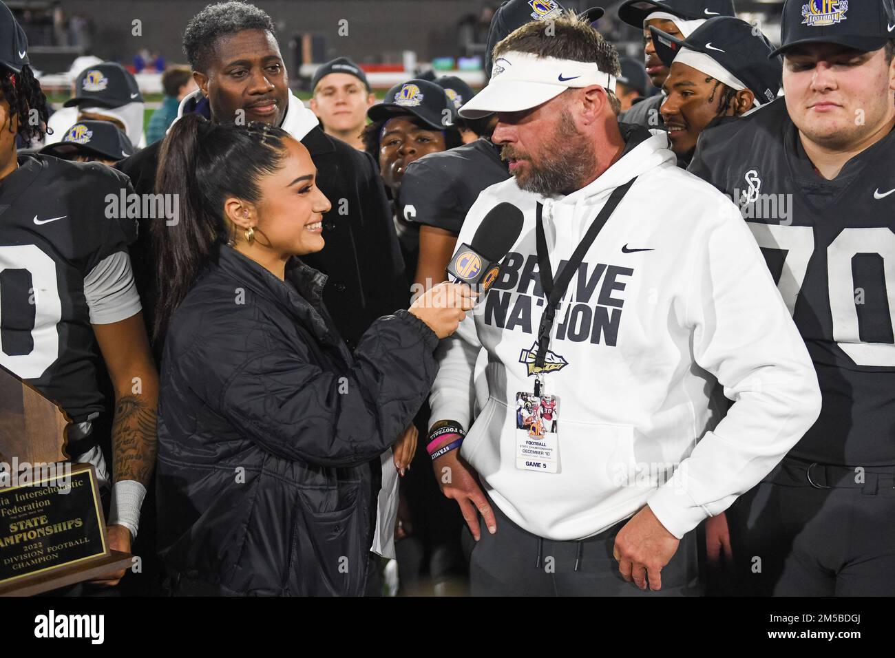St. John Bosco Braves head coach Jason Negro (right) is interviewed by ...