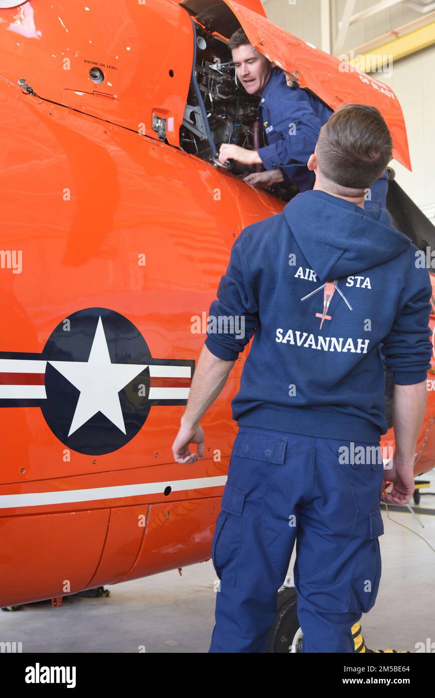 U.S. Coast Guard Petty Officer 3rd Class Bryce Kitchen (top), an ...