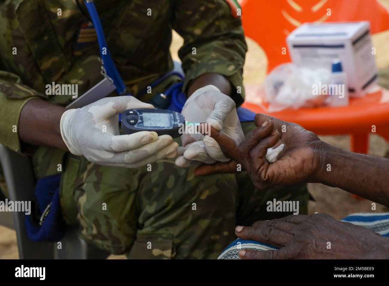 A Côte d’Ivoire Army medic tests blood glucose levels in local ...