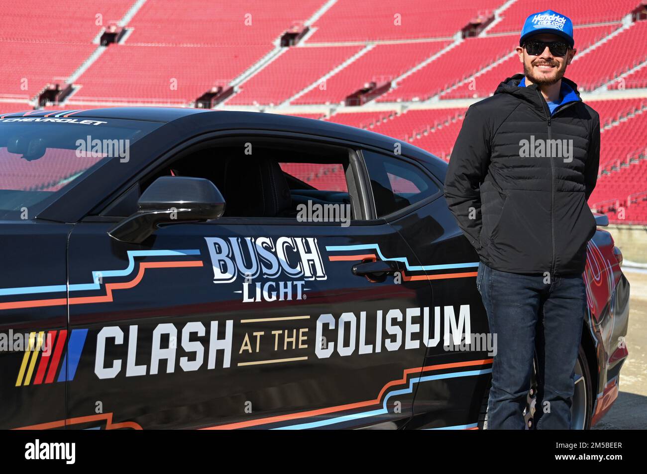 NASCAR driver Kyle Larson poses with a Chevy Camaro during a ...