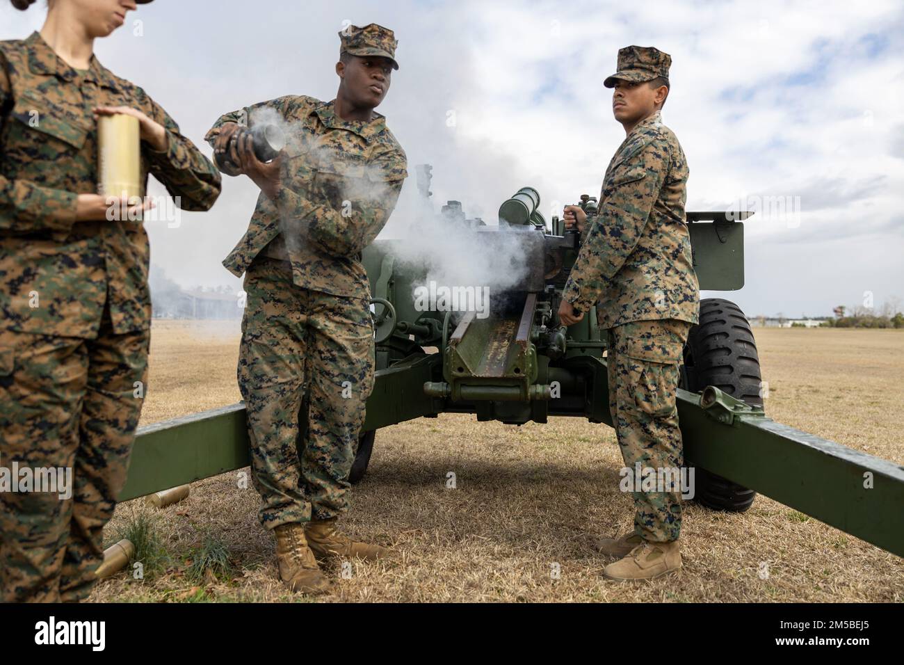 U.S. Marines with Kilo Battery, 2d Battalion, 10th Marines, reload a ...