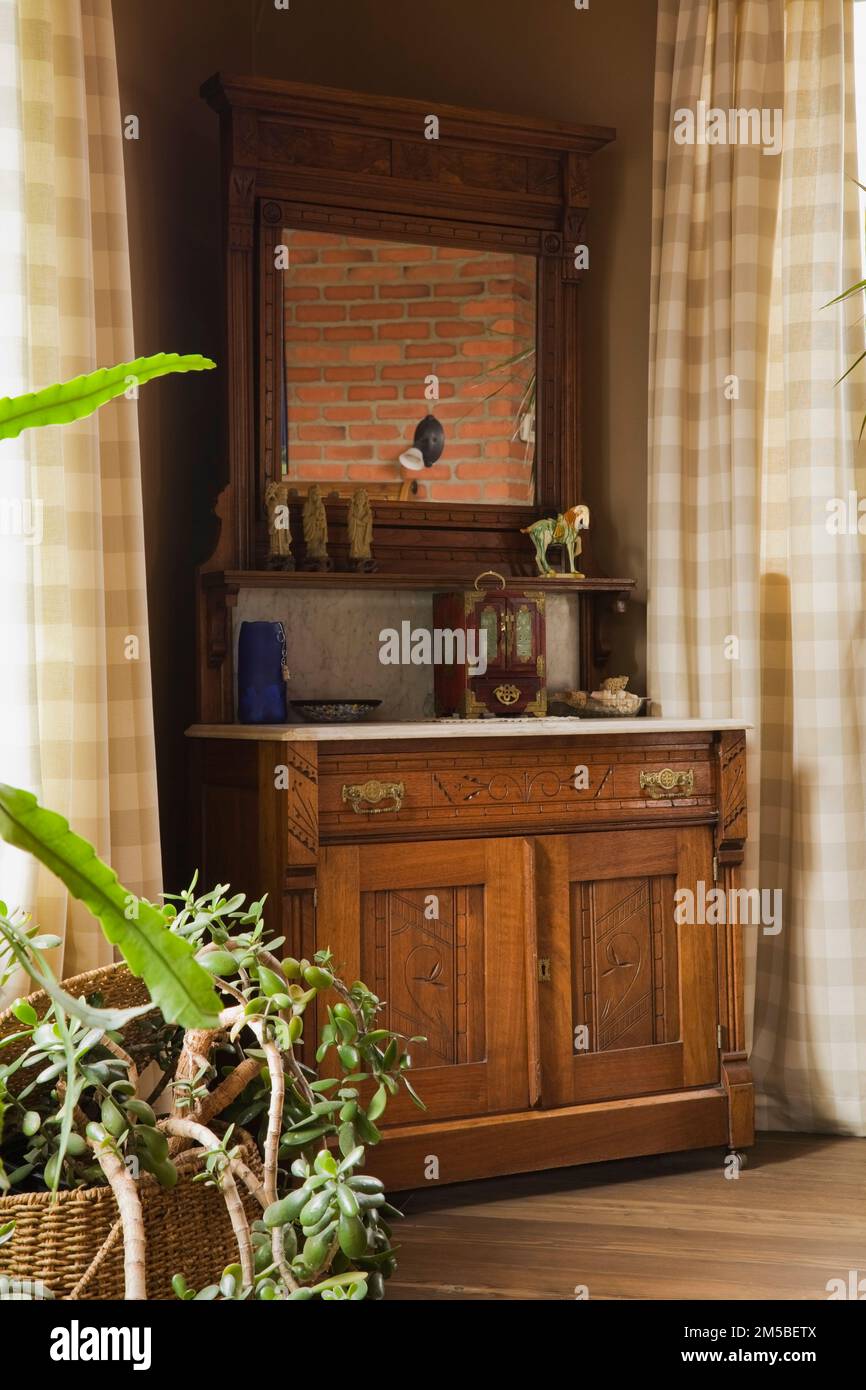 Green plants and antique wooden dresser in master bedroom on upstairs ...