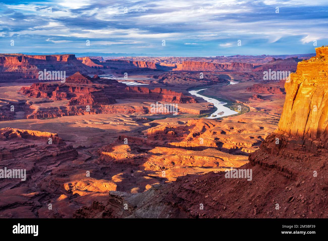 The Colorado River winds below Pyramid Butte, evaporation ponds and ...