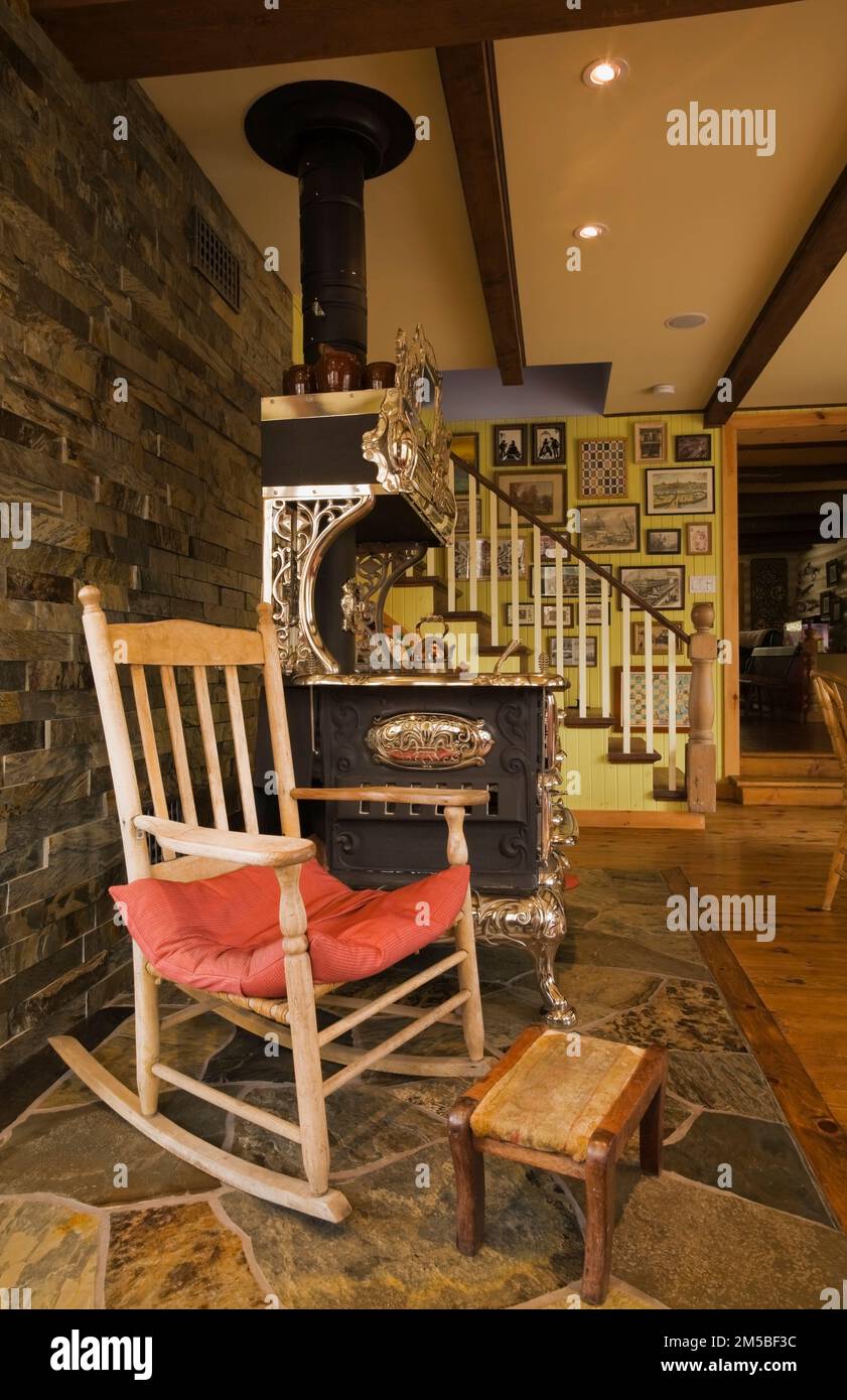 Old wooden rocking chair next to antique Royal model wood burning ...