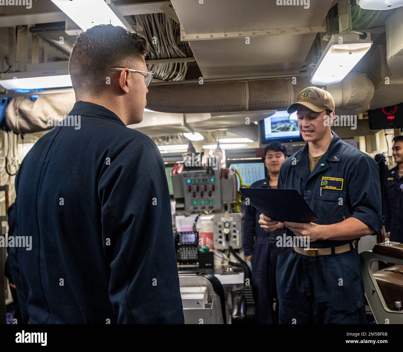 SOUTH CHINA SEA (Feb. 21, 2022) Ensign Joshua Freilich (right), from ...