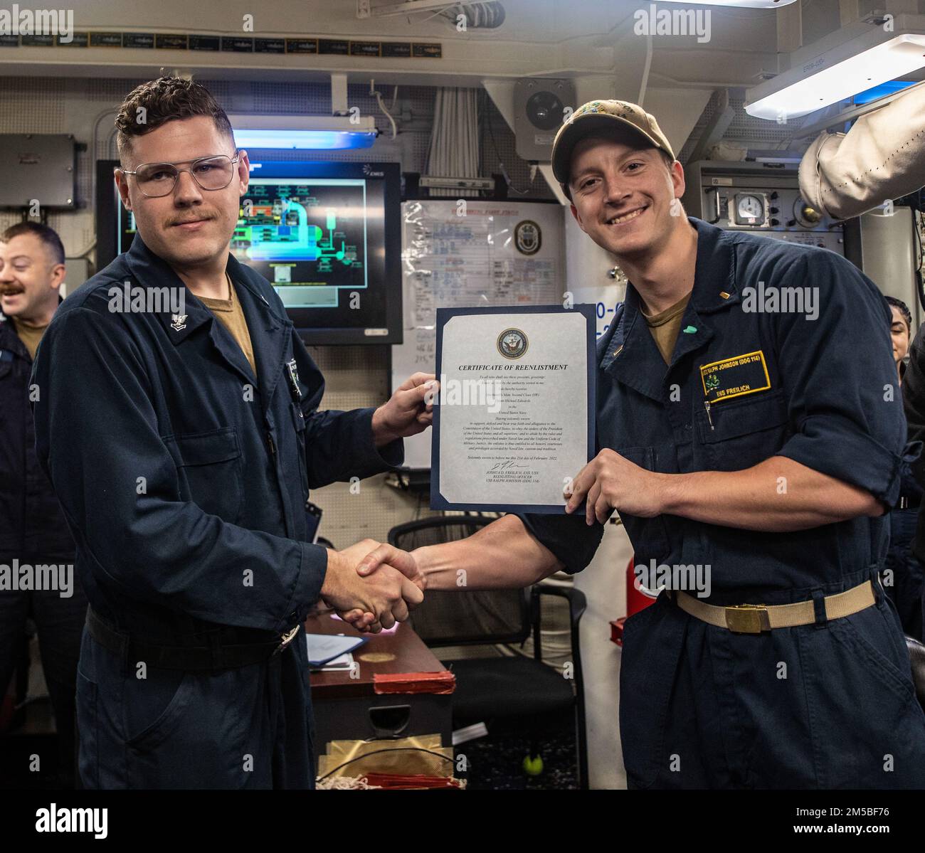 SOUTH CHINA SEA (Feb. 21, 2022) Ensign Joshua Freilich (right), from ...