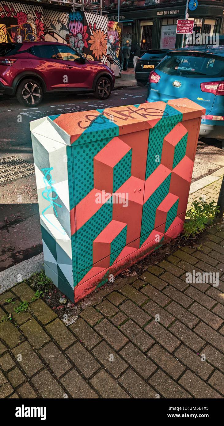 A vertical shot of art graffiti design on a street electricity box of ...