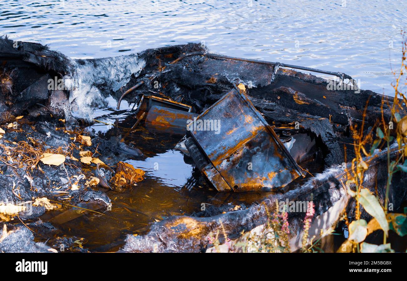 High angle view of burned out motorboat Stock Photo - Alamy