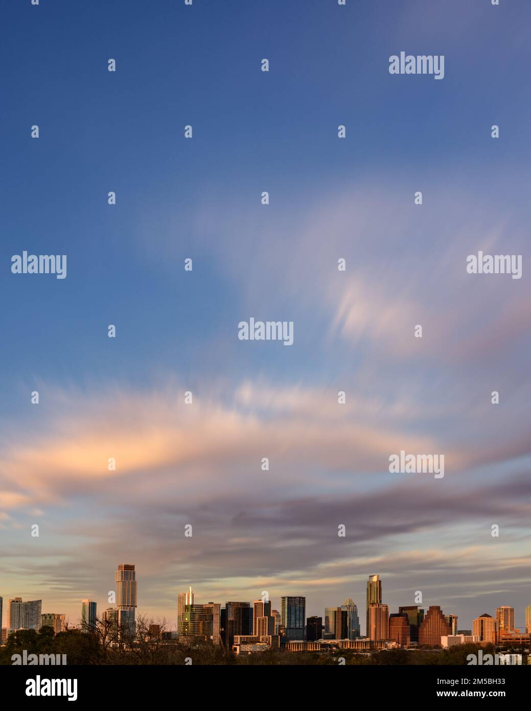 A vertical shot of the city of Austin with a beautiful sunset in the ...