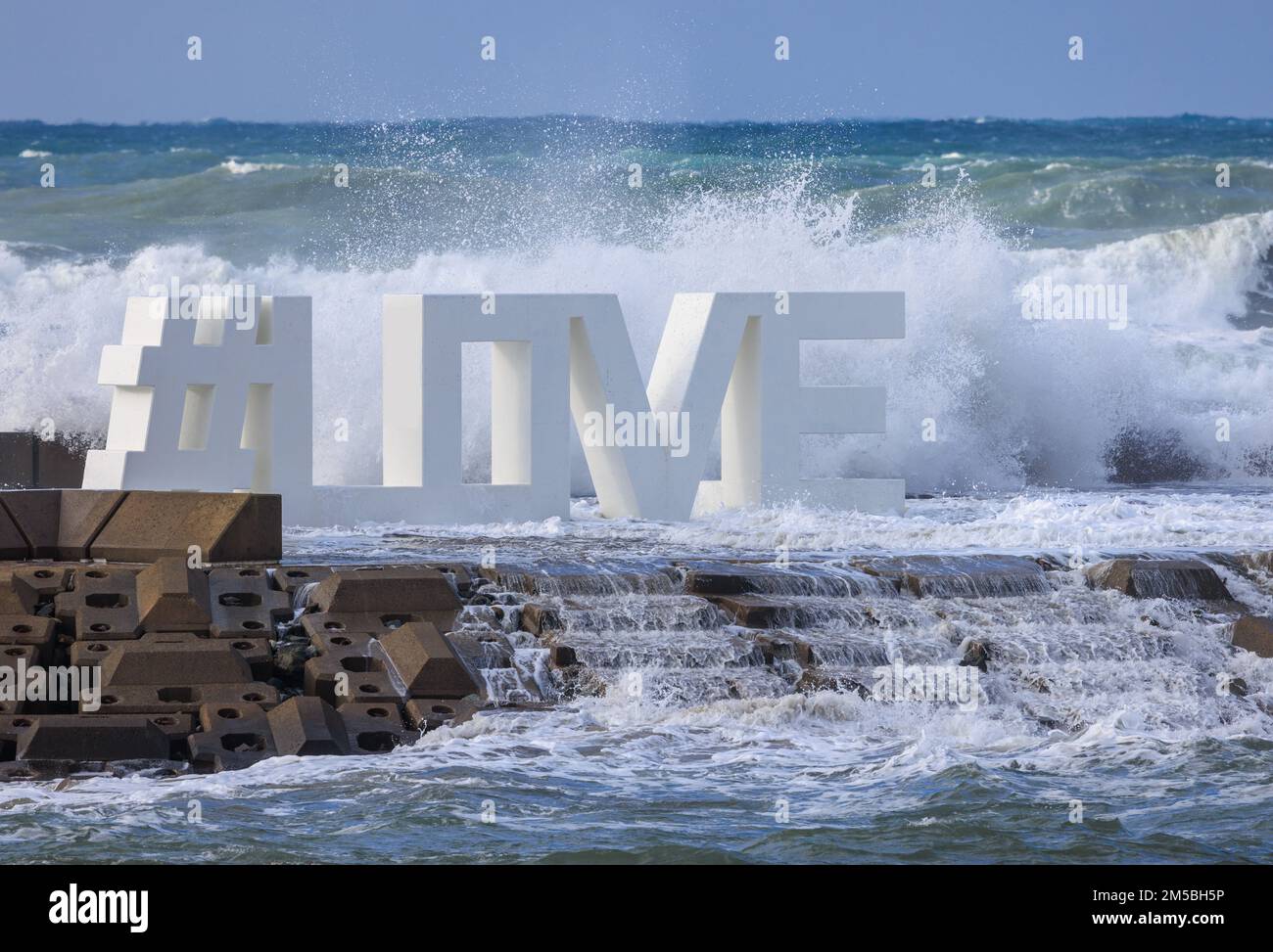 Waves crash on the word love in turbulent ocean waters Stock Photo - Alamy