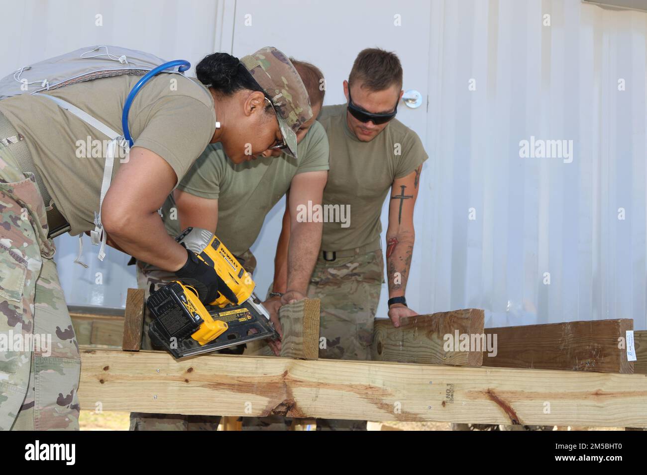 Base Engineer Emergency Force (BEEF) Airmen set joists for patio ...