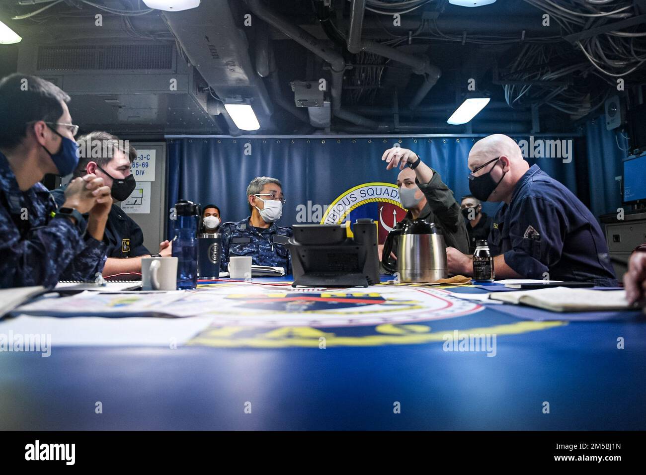 PACIFIC OCEAN (Mar. 7, 2022) Capt. Greg Baker, center right, commodore of Amphibious Squadron ...